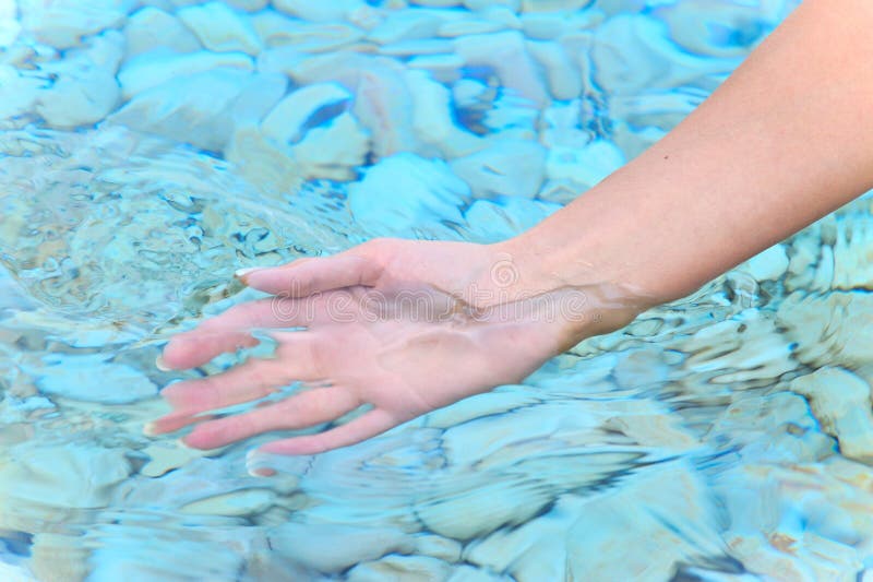 Woman hand in the water stock image. Image of sunlight - 5994363