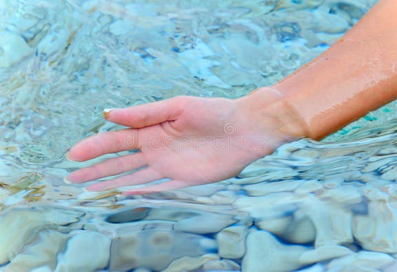 Woman hand in the water stock image. Image of fingers - 6464789