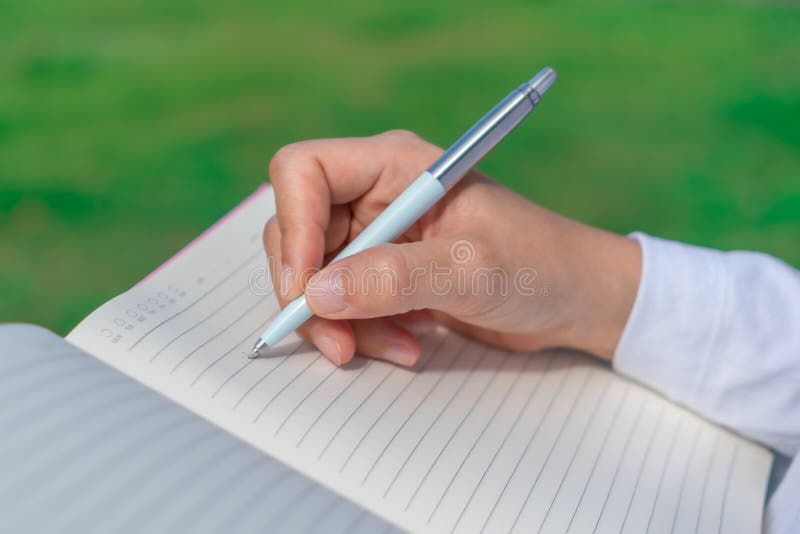 Woman Hand Writing Down in Small White Memo Notebook for Take a Note ...