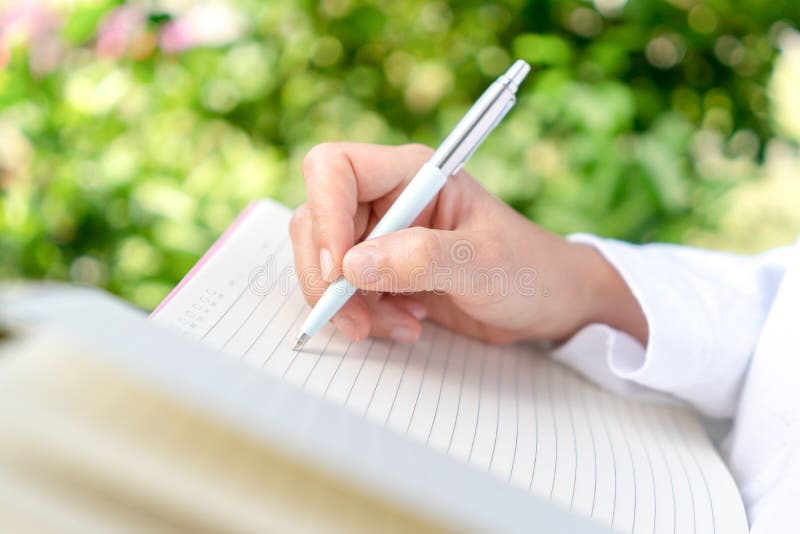Woman Hand Writing Down in Small White Memo Notebook for Take a Note ...