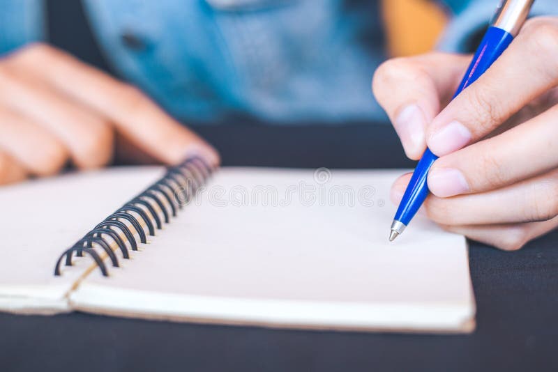 Woman Hand is Writing on a Note Pad with a Pen in the Office. Stock ...