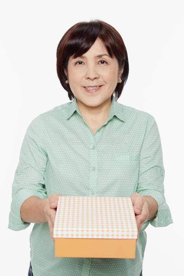 Woman Handing Out a Gift Box Stock Photo - Image of lifestyle, mature ...