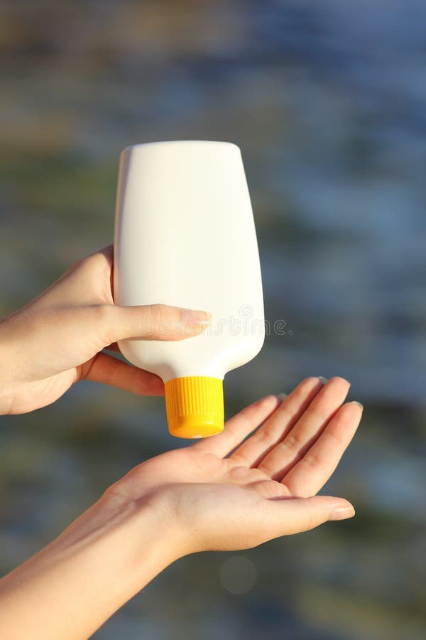 Hands Applying Sunscreen Protection from a Bottle Stock Image - Image ...
