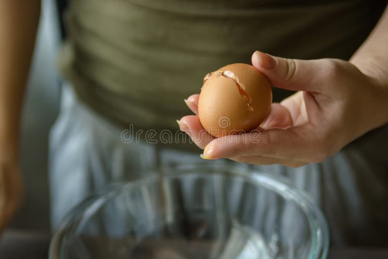 Woman Breaking Egg Separating Yolk And Egg White Stock Photo - Image of ...