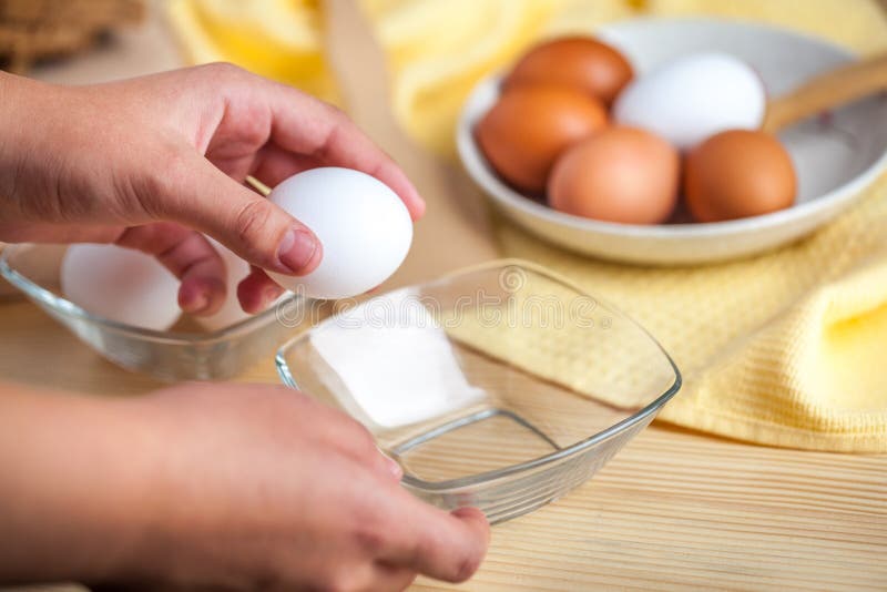 Woman Hands Breaking an Egg, Eggs at the Background Stock Image - Image ...