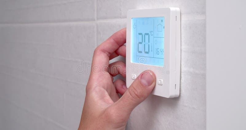 Man Changing the Temperature on a Programmable Hvac System on the House ...