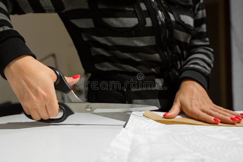 Female Hands are Cutting the Fabric with Tailors Scissors on the ...