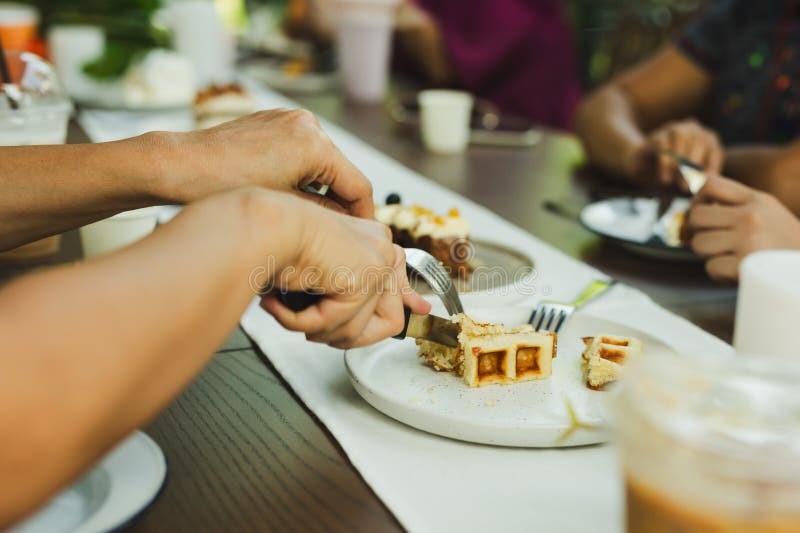 Woman Hands Cutting Waffles with Fork and Knife on Plate in Cafe. Stock ...