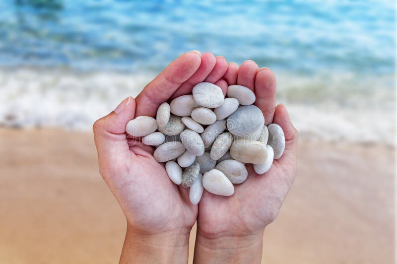 Woman Hands Holding Small Stones in Hands on Beach Background Stock ...