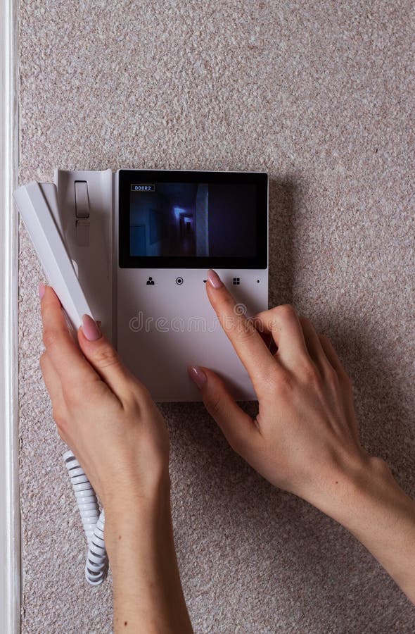 Woman Hands Opening Door with an Intercom with a Camera, Installed on ...