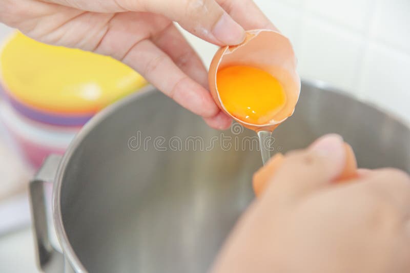 Woman Hands To Egg Shells and Separate Egg Yolk Stock Photo - Image of ...