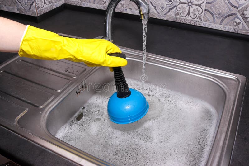 Woman Hands Unclogging Kitchen Sink with Plunger. Overflowing Kitchen ...