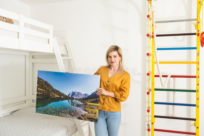 Woman Hanging a Photo Canvas on a Wall. Stock Photo - Image of blank ...