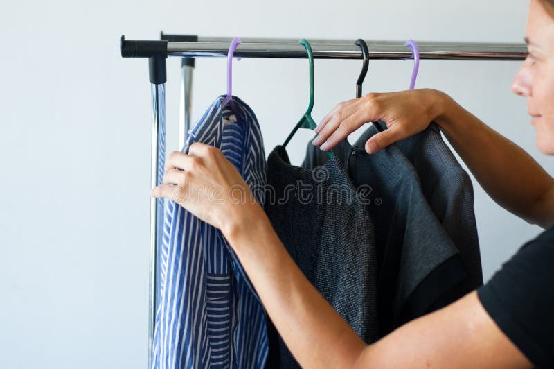 Woman Hangs Jacket on the Hanger Stock Photo - Image of adult, hangs ...
