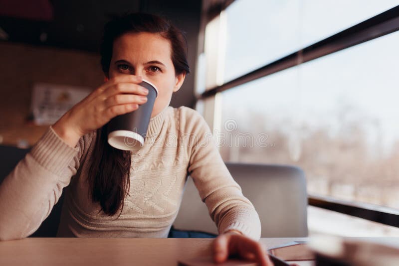 The Woman Has a Rest in Cafe, Sits at a Table and Has Tea Stock Photo ...