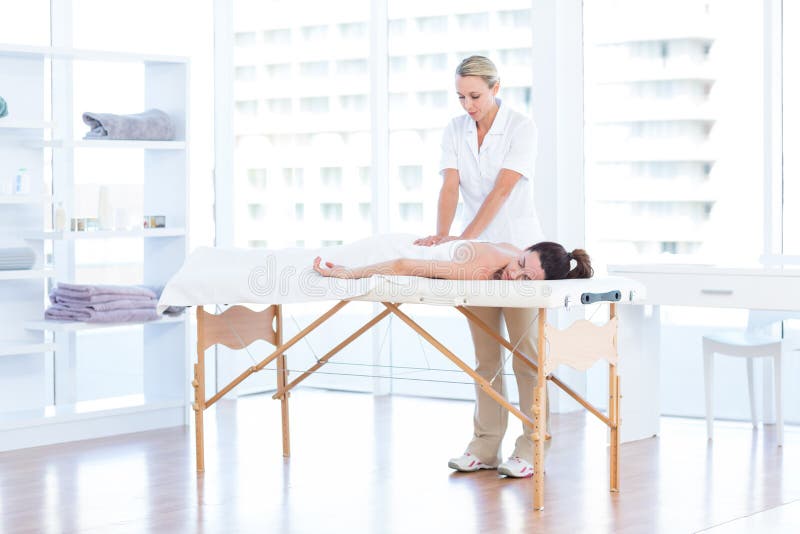 Woman having back massage stock photo. Image of clinic - 53046454