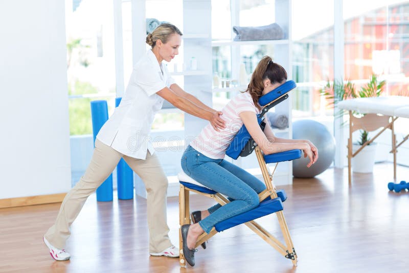 Woman having back massage stock photo. Image of chair - 53076916