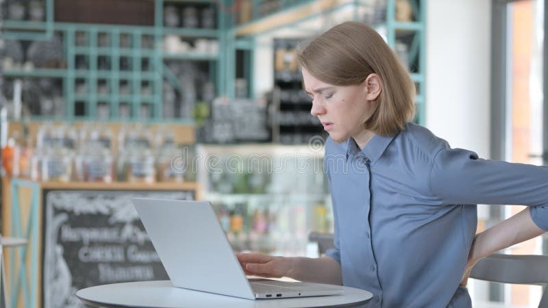 Young Woman Having Back Pain while Using Laptop Stock Photo - Image of ...