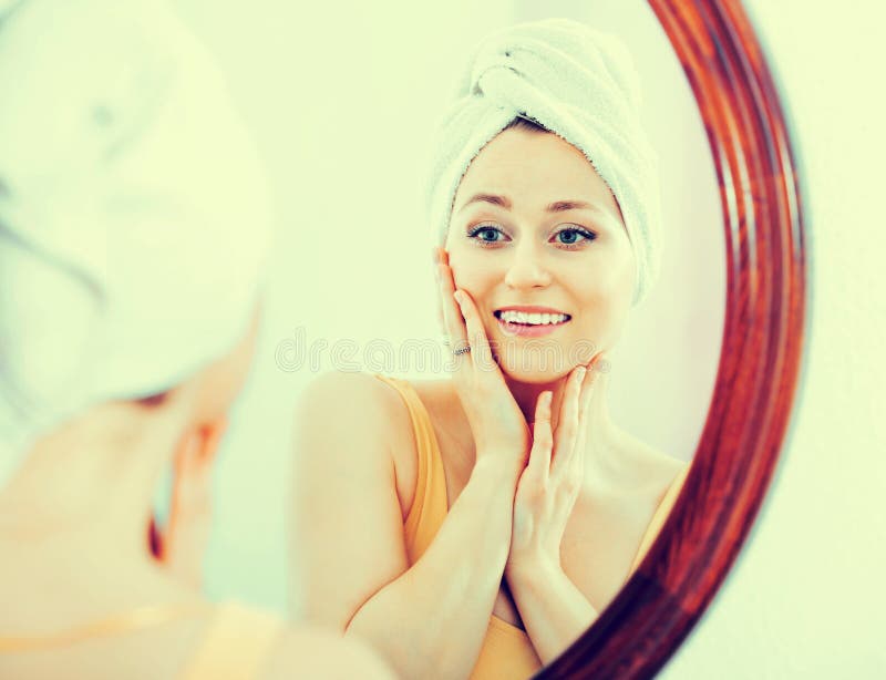 Woman Having a Look at Her Face at the Mirror Stock Image - Image of ...