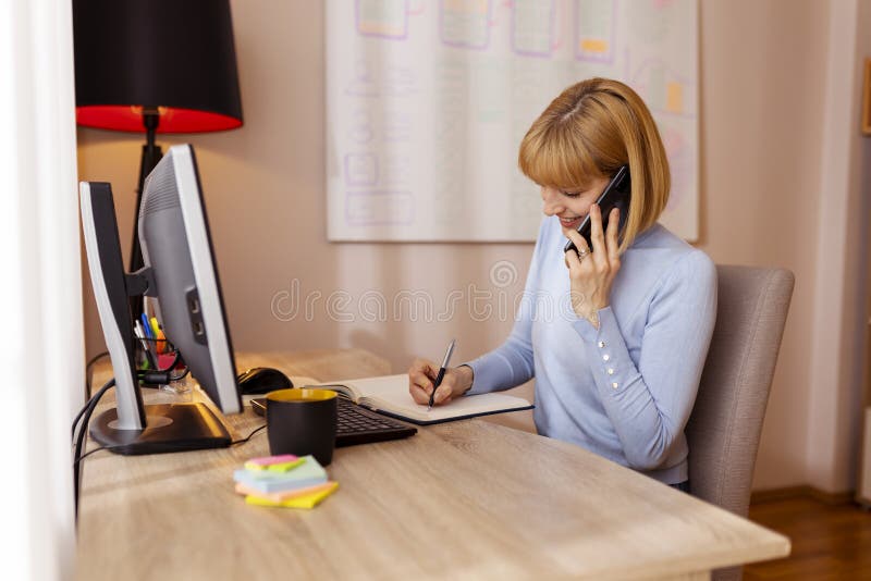 Woman Taking Notes while Having Phone Conversation Stock Image - Image ...