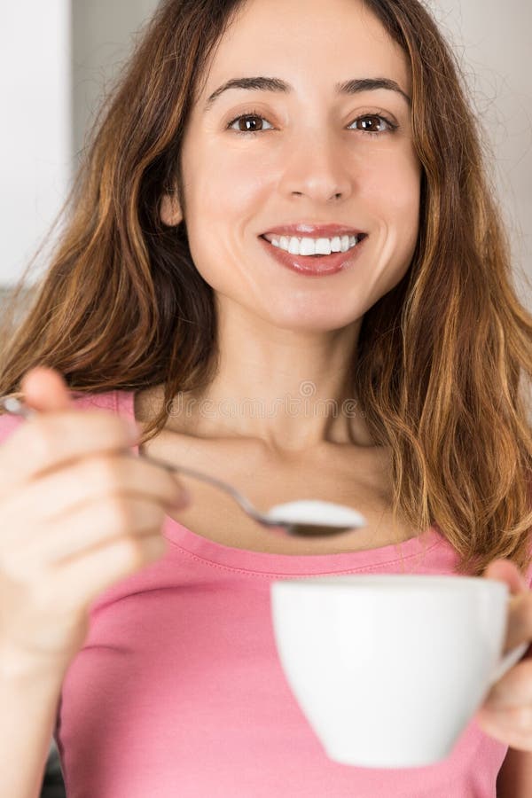 Woman Having Sugar in Her Coffee Stock Photo - Image of smiling ...