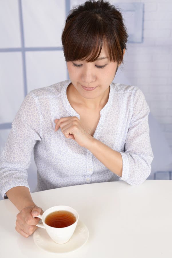 Woman having tea stock photo. Image of drink, home, expression - 143195066