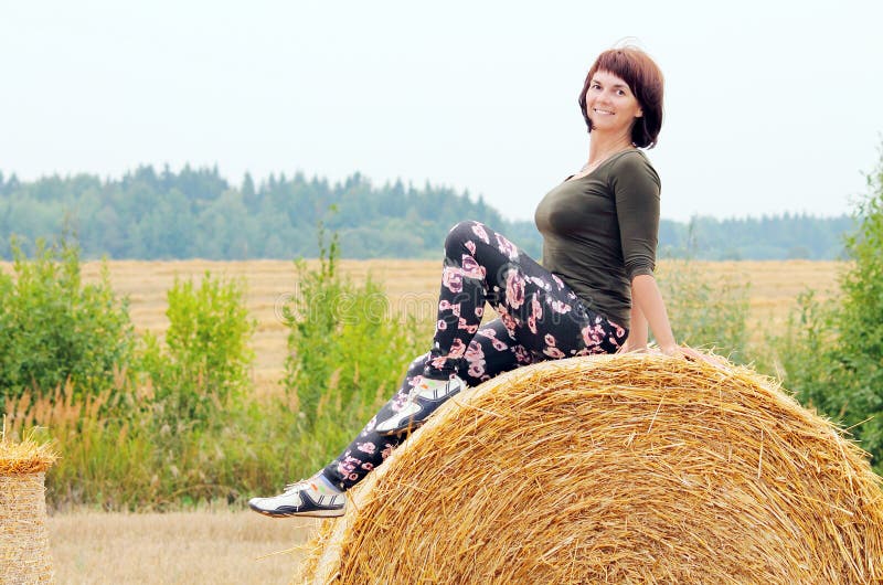Woman on the haystack stock photo. Image of forest, manufacturing ...