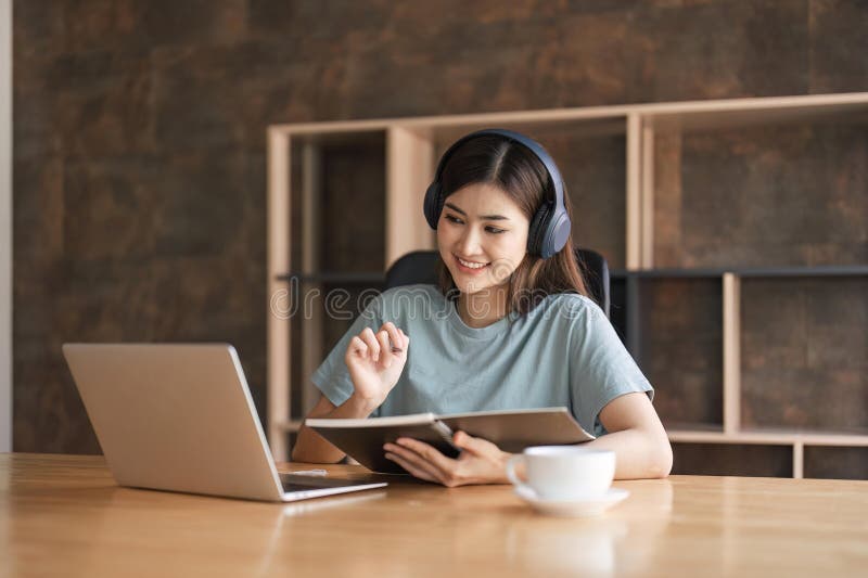 Woman in Headphones Taking Notes and Working from Home Stock Image ...