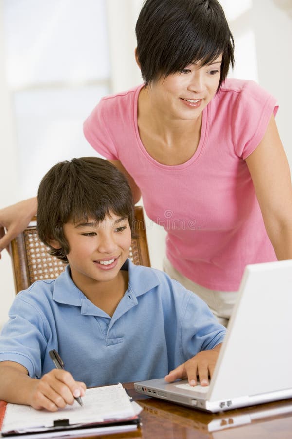 Woman Helping Boy with Laptop Doing Homework Stock Photo - Image of ...