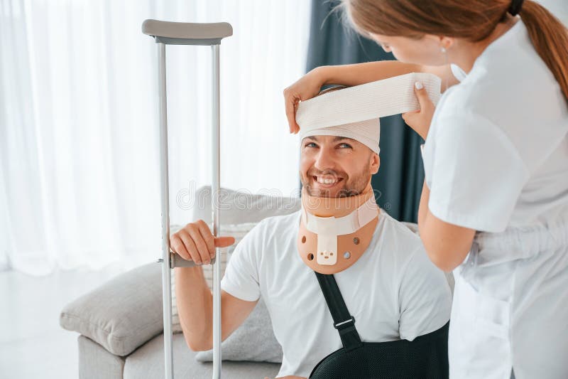 Woman is Helping Injured Man at Home Stock Photo - Image of assistance ...