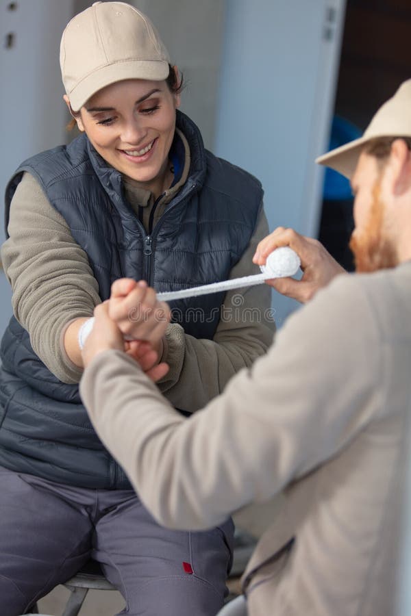 Woman Helping Man Worker after Accident Stock Photo - Image of health ...