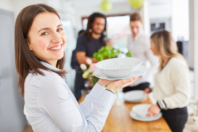 Woman Helps Carry Table Setting with Dishes Stock Image - Image of ...