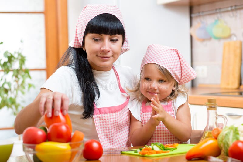 Woman and Her Daughter are Cooking at Kitchen Stock Photo - Image of ...
