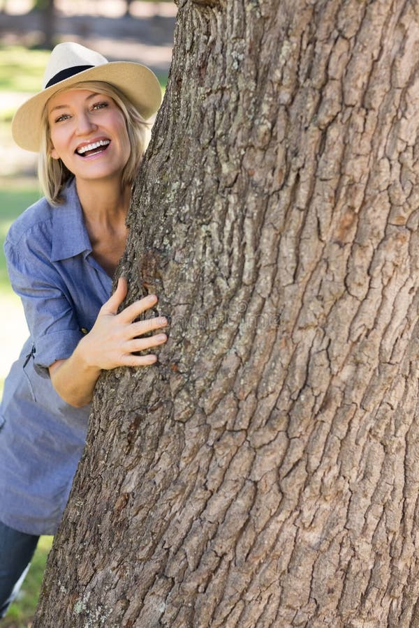 Woman Hiding Behind Tree Trunk Stock Image - Image of outdoors ...