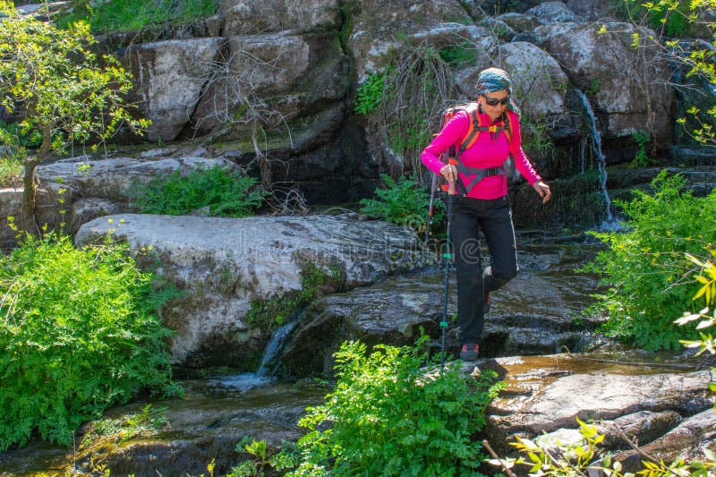 Woman Hiker Crossing a River by the Rocks Stock Photo - Image of hike ...