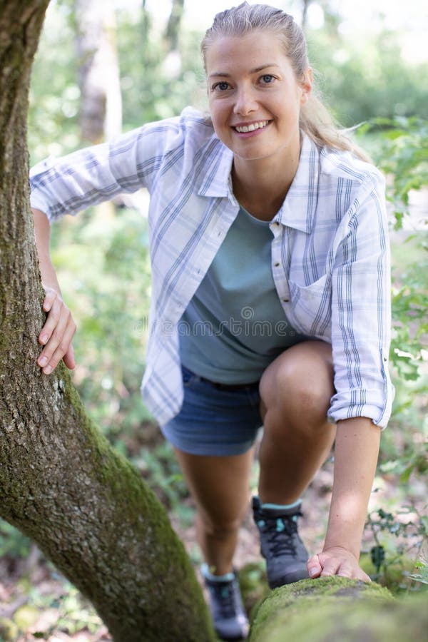 Woman Hiking Climbing Over Tree Trunk Stock Image - Image of girl ...