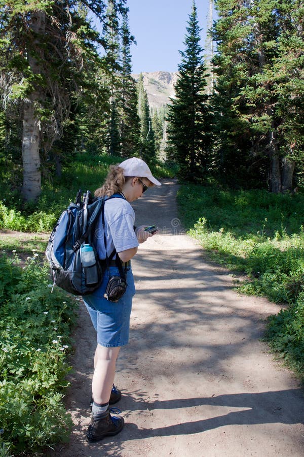 Woman hiking to a geocache stock image. Image of hunt - 20923005