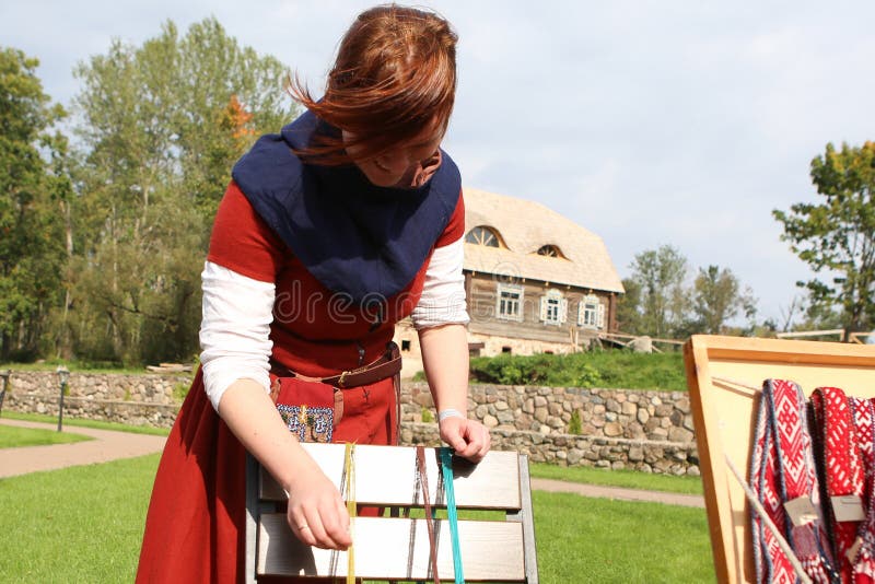 A Woman in an Historical Suit Shows a Master Class in Knitting ...