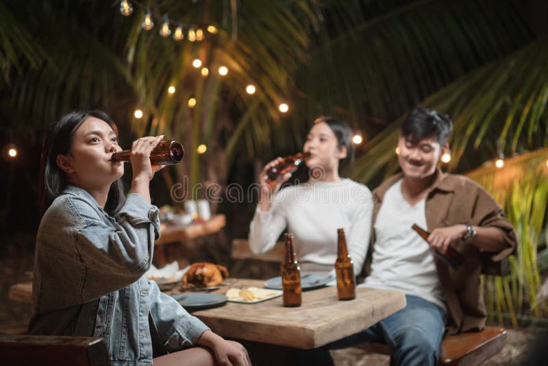 Woman Holding a Beer Bottle Drinking at a Party Stock Image - Image of ...