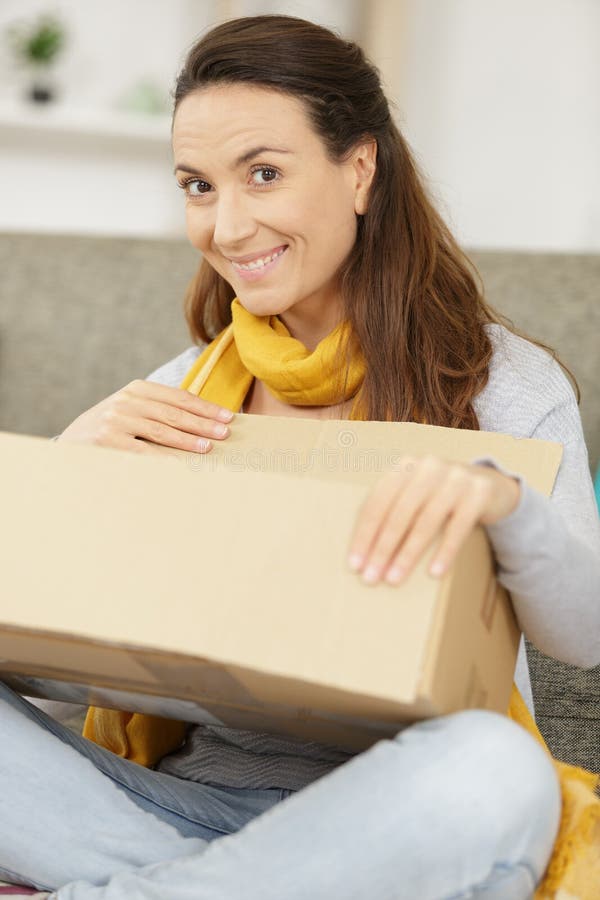 Woman holding box smiling stock photo. Image of carton - 171371556