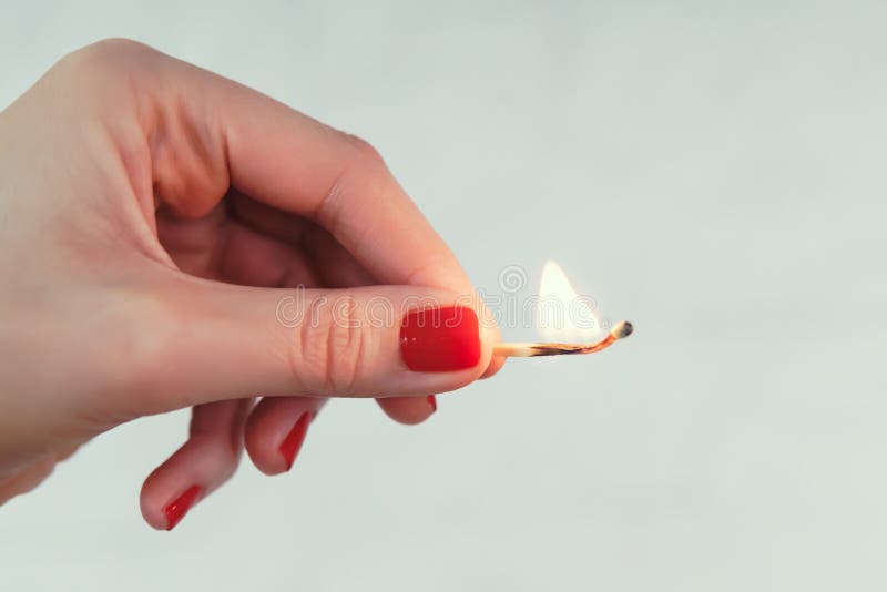 Woman Holding a Burning Match Stock Photo - Image of danger, glow: 83323776