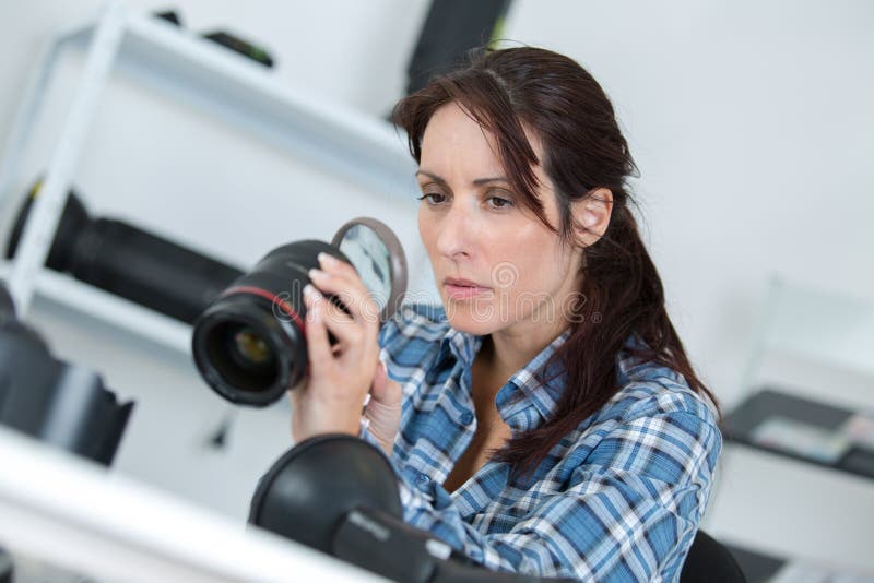 Woman holding camera lens stock photo. Image of focal - 102051144