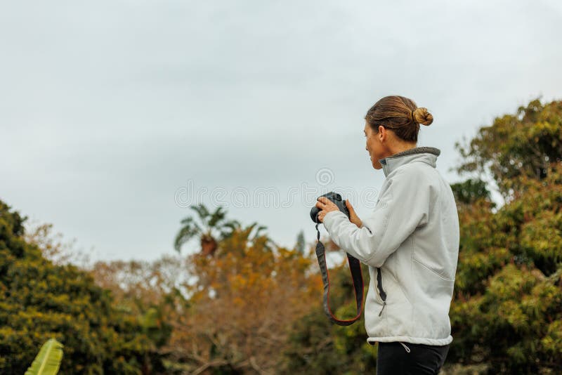 Woman Holding Camera Looking into African Bush Stock Photo - Image of ...