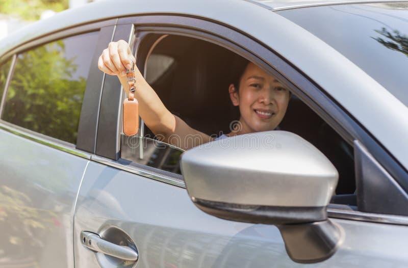 Woman Holding a Car Key in Her Hand while Sitting in Her Car. Stock ...