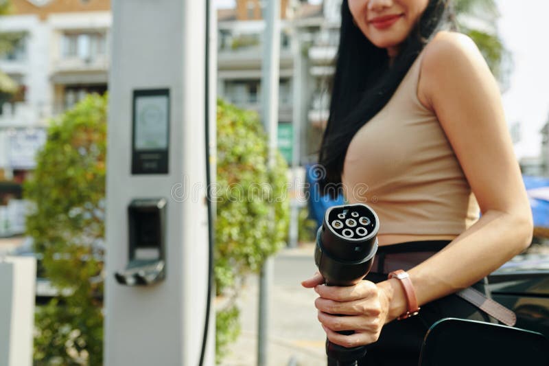 Woman Standing at EV Charging Station Stock Image - Image of station ...