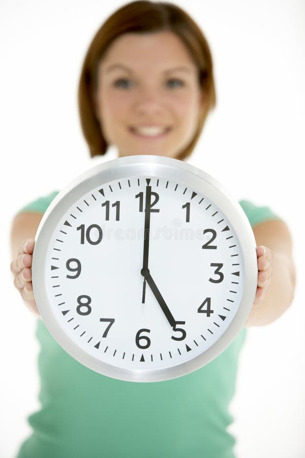 Woman Holding Clock Showing 5 O Clock Stock Photo - Image of foreground ...