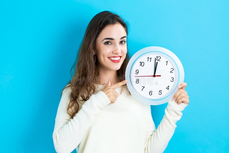 Woman Holding Clock Showing Nearly 12 Stock Image - Image of person ...