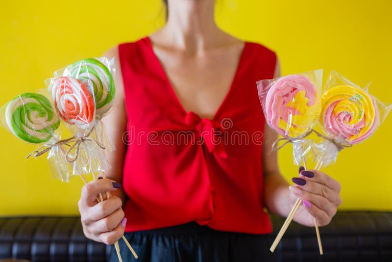 A Woman Holding a Colorful Candy in Hand. Stock Image - Image of color ...