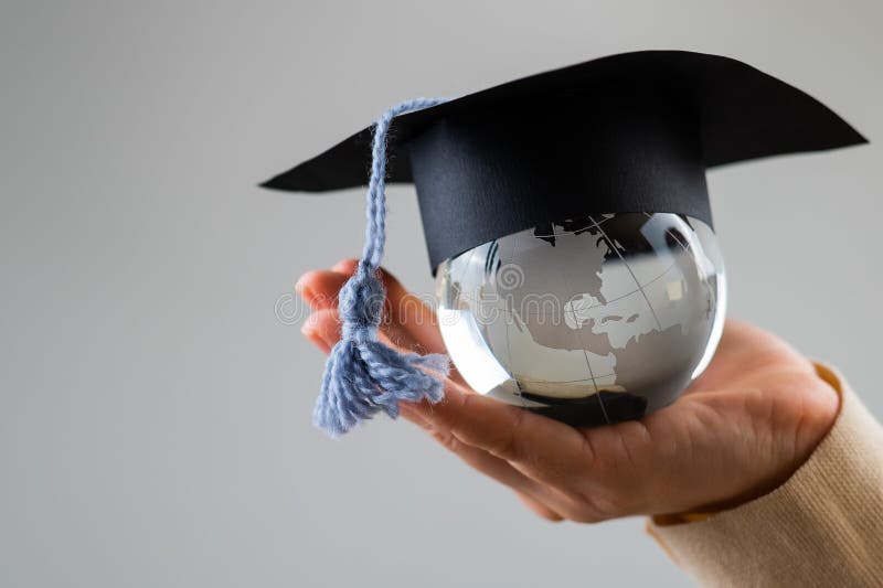 Woman Holding a Crystal Globe Wearing a Graduation Cap. Stock Image ...