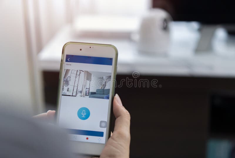 Woman Holding Device As Remote Control To Connect a CCTV for the Safety ...